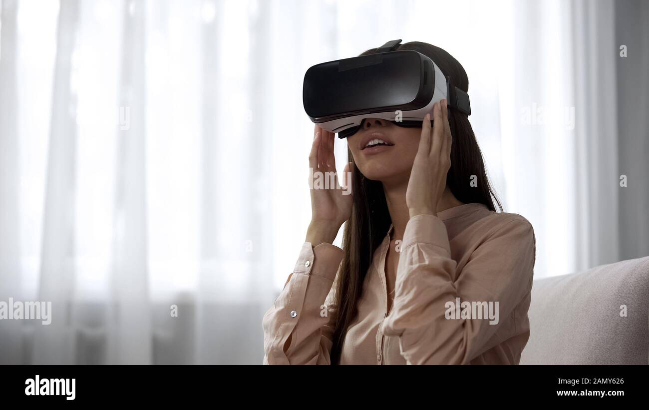 Surprised girl using VR headset for first time, overwhelmed with ...