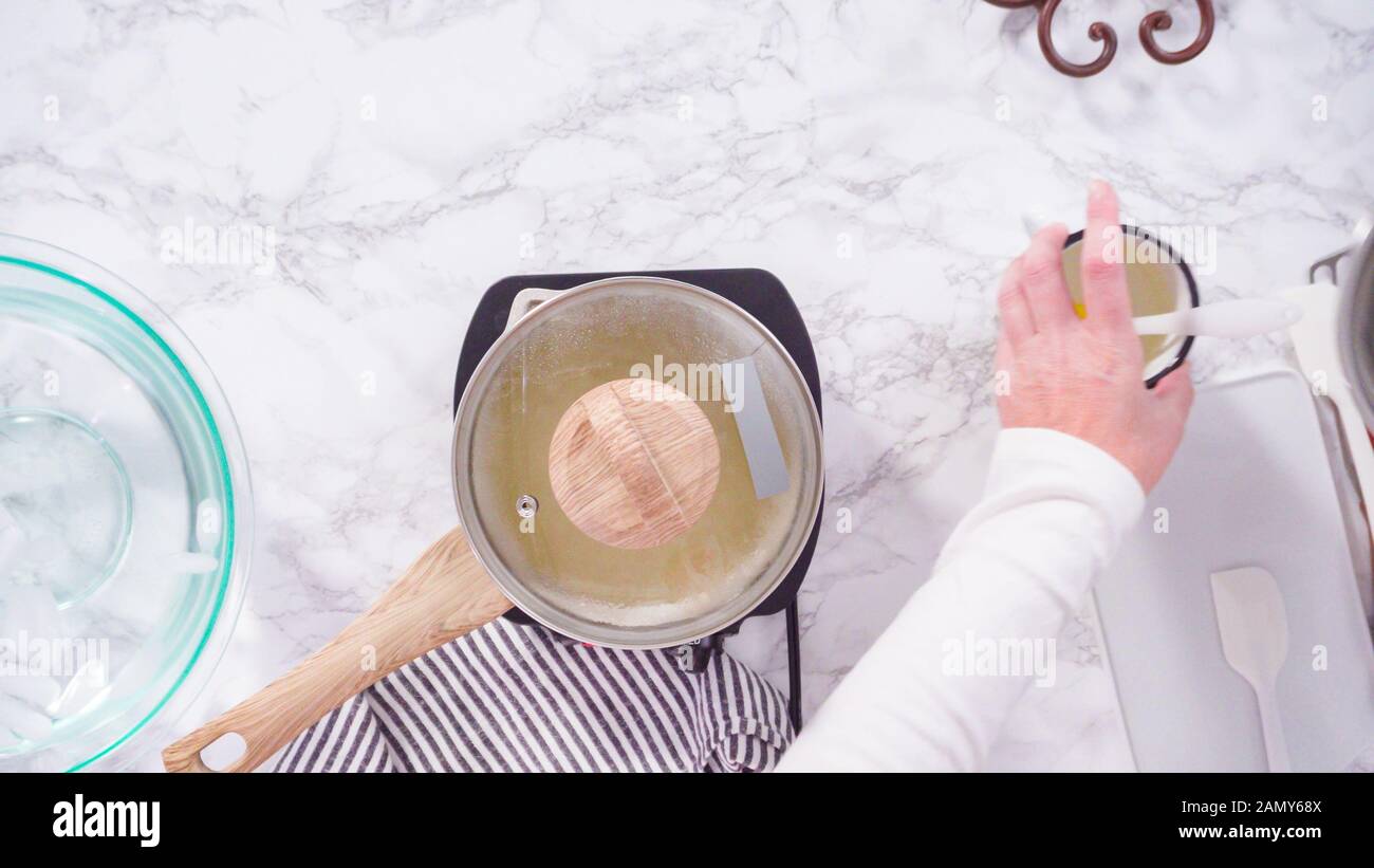 Flat lay. Step by step. Caramelizing sugar in a small cooking pot over ...