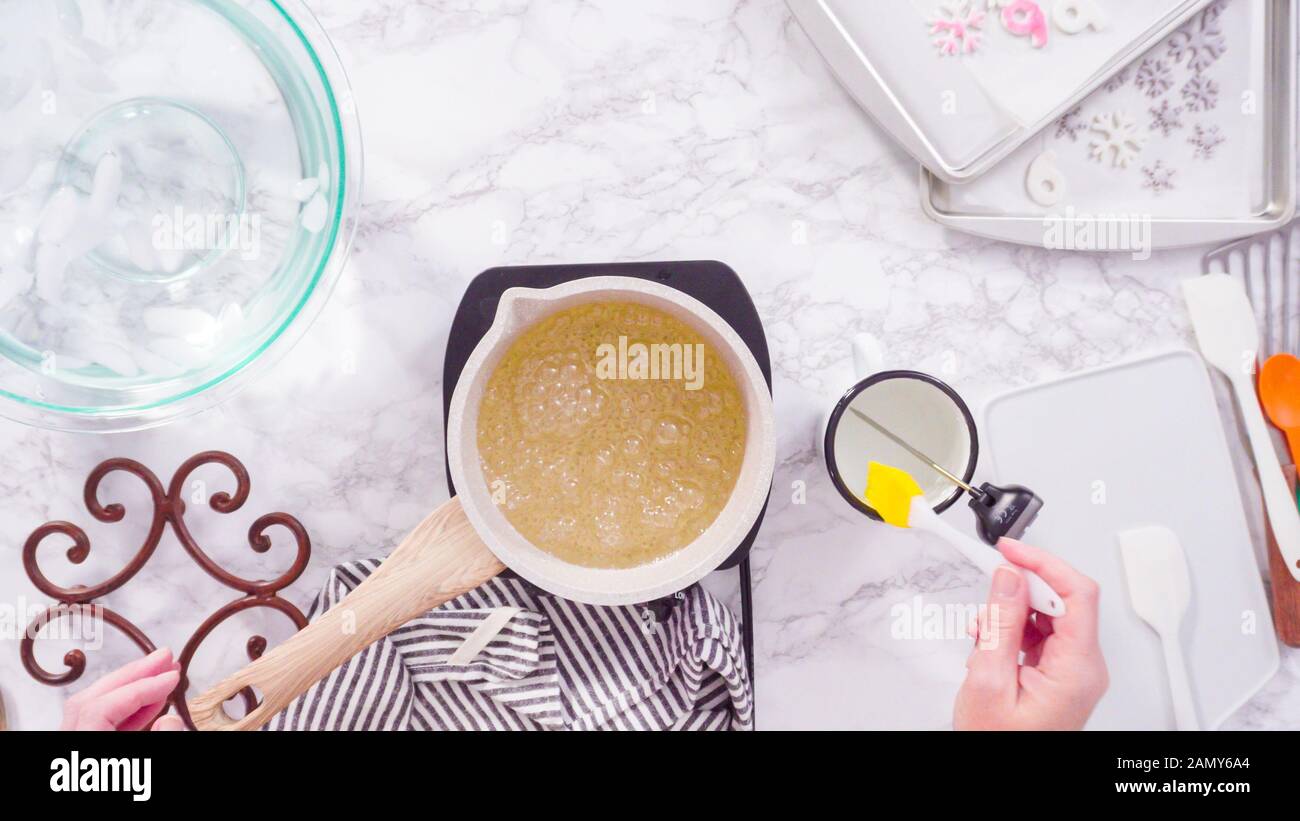Flat lay. Step by step. Caramelizing sugar in a small cooking pot over ...