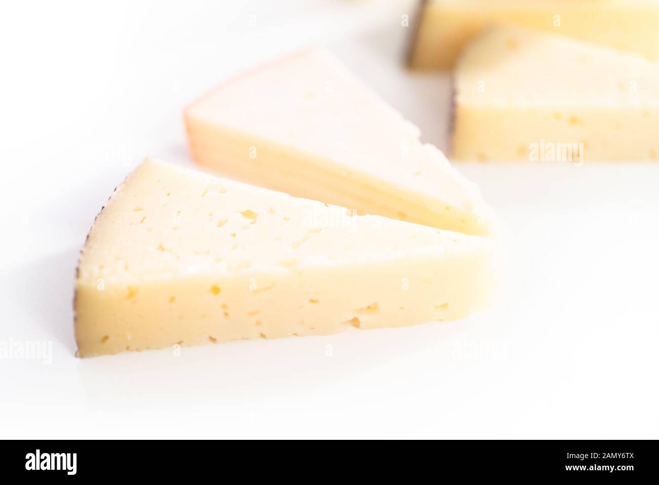Variety of large wedges gourmet cheese on a white background Stock ...