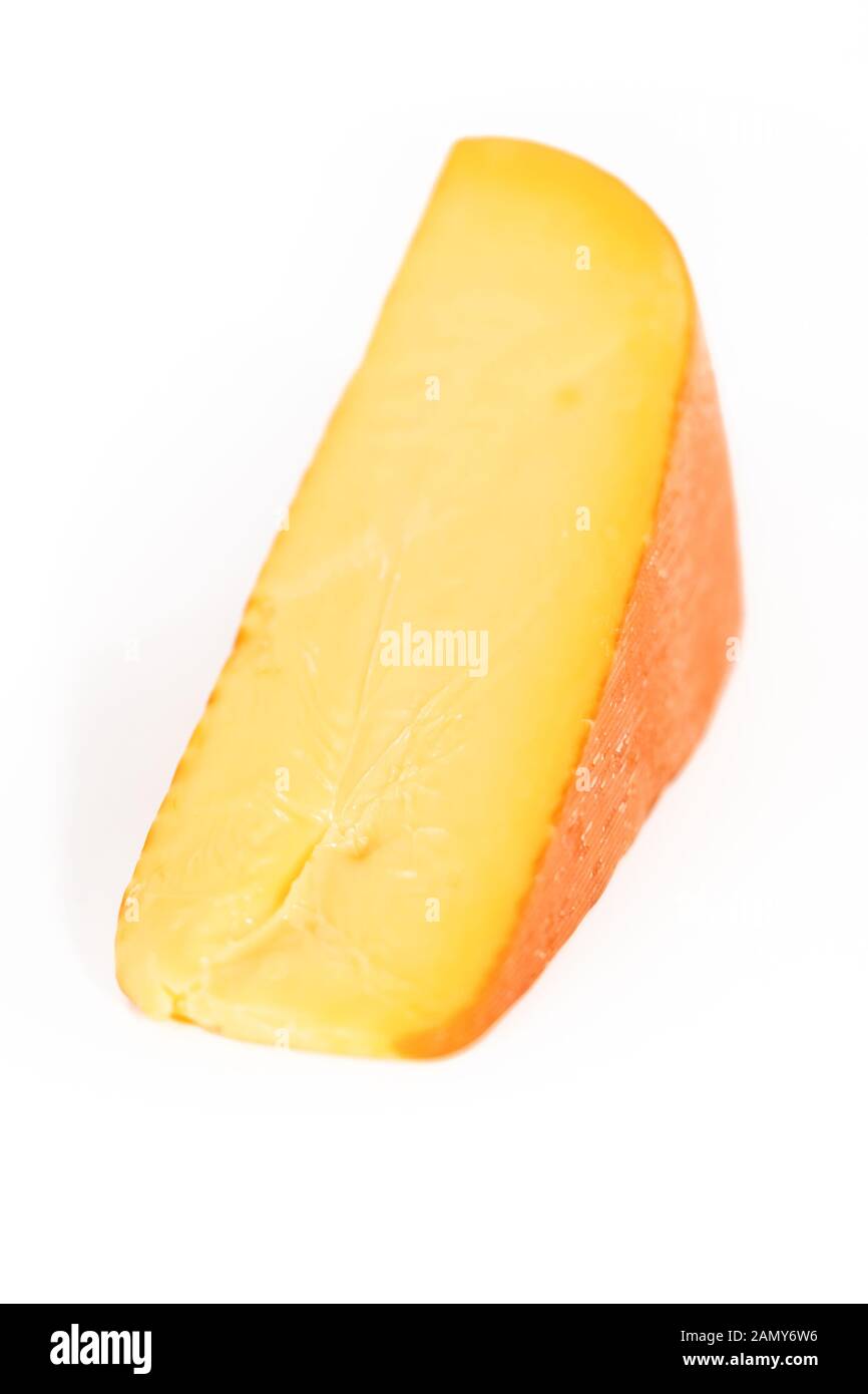 Large slice of smoked gouda cheese on a white background Stock Photo ...