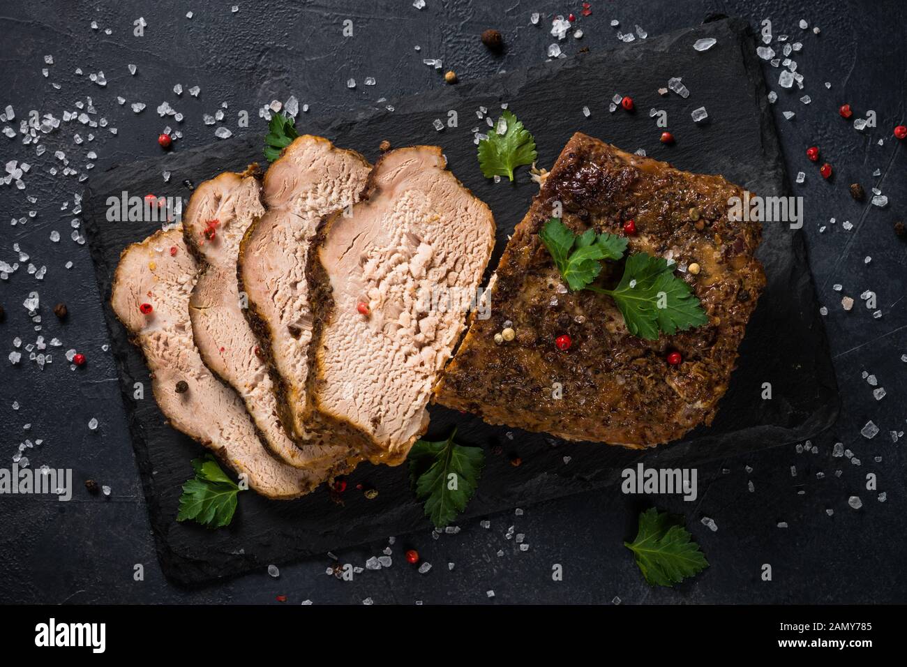 Baked pork meat ham on black kitchen table Stock Photo - Alamy