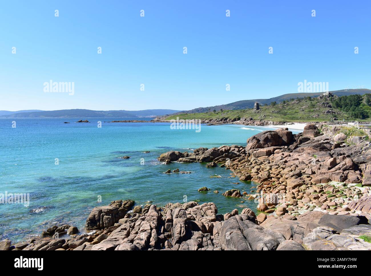 Bay with beach, turquoise water and blue sky. View from the rocks. San ...