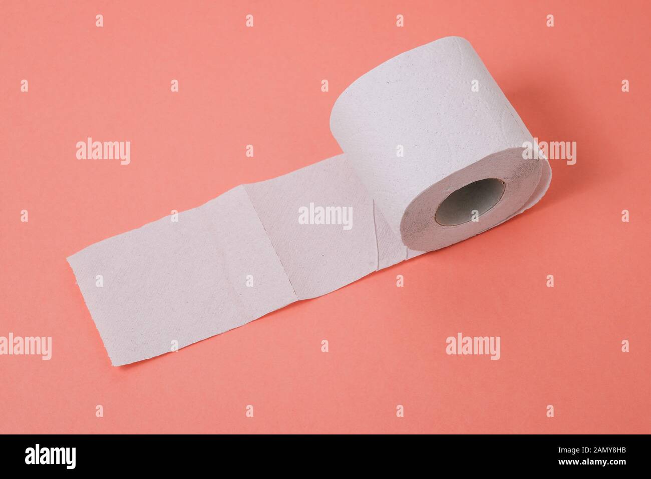 Expanded roll of toilet paper on a pink background. A place to write ...