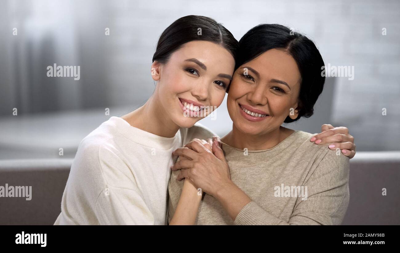 Female embracing, looking into camera, refreshed face after skin care ...