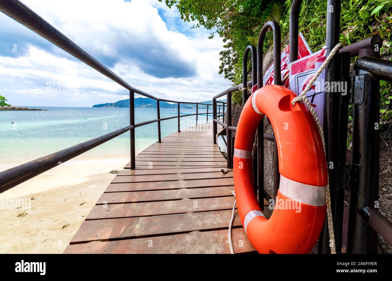 Wooden walkway ramp on the shore of Andaman Sea. Famous tourist ...