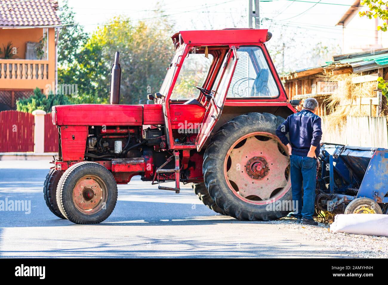 Old and dirty tractor ready for working on field Stock Photo - Alamy
