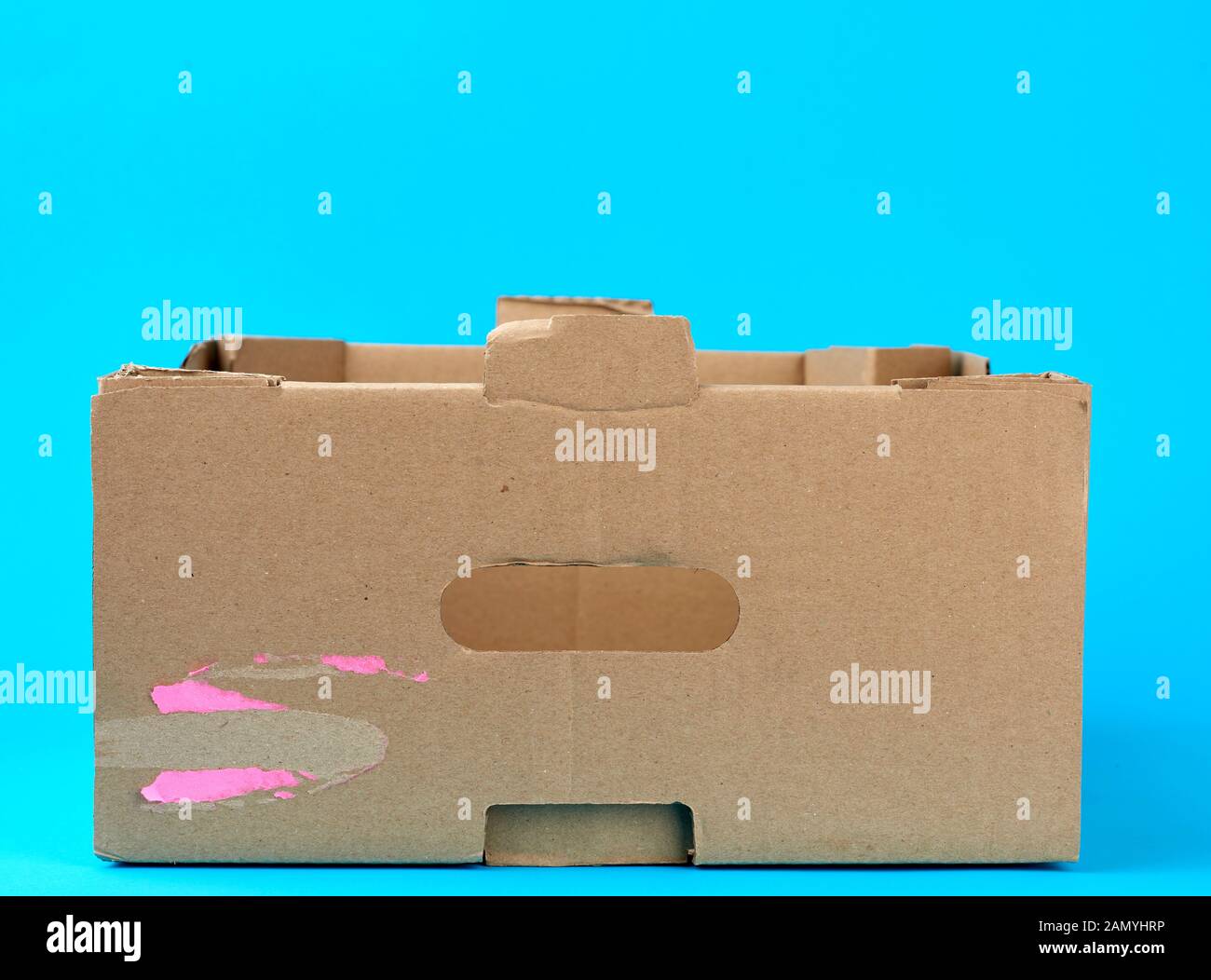 rectangular empty cardboard box of brown paper on a blue background ...