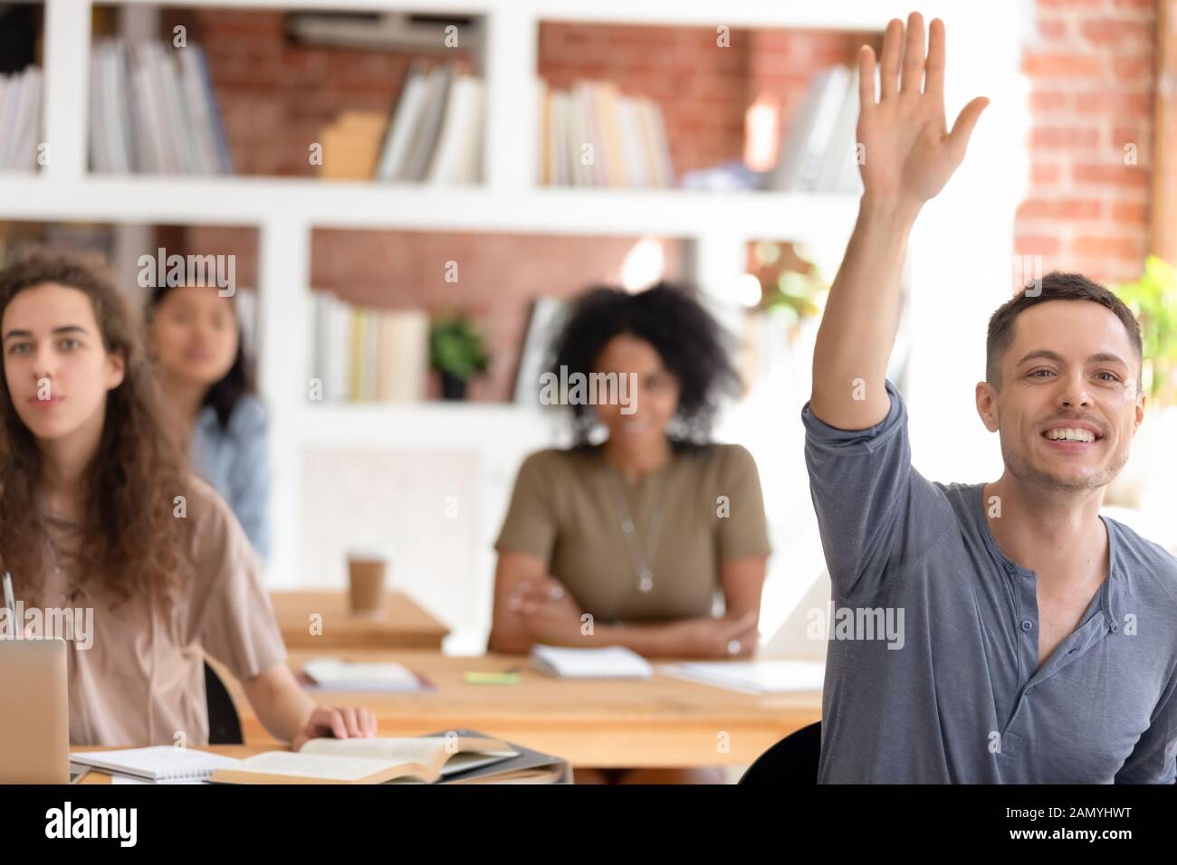 Motivated male student ask hand asking question at lesson Stock Photo ...