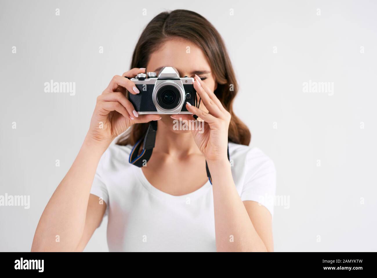 Female photographer with camera photographing in studio shot Stock ...