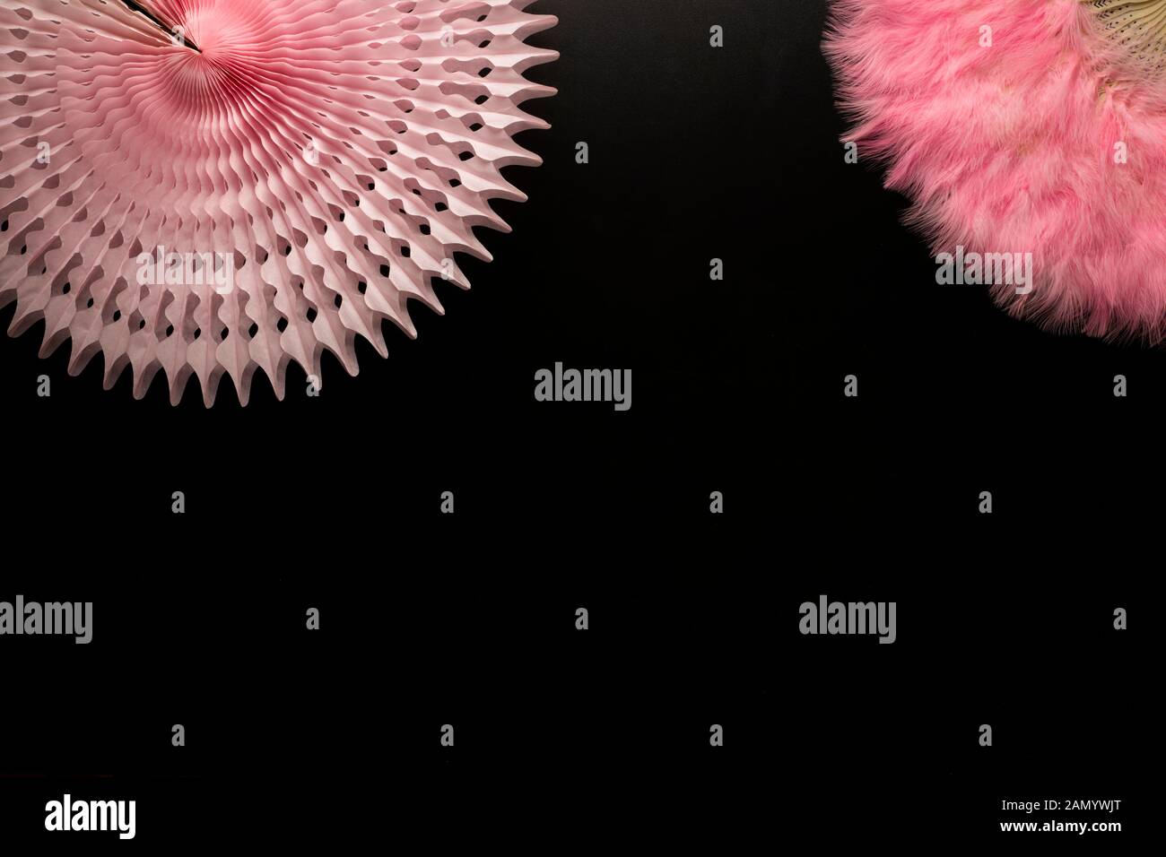 Carnival objects on a black background. Pink Chinese fan and paper star ...
