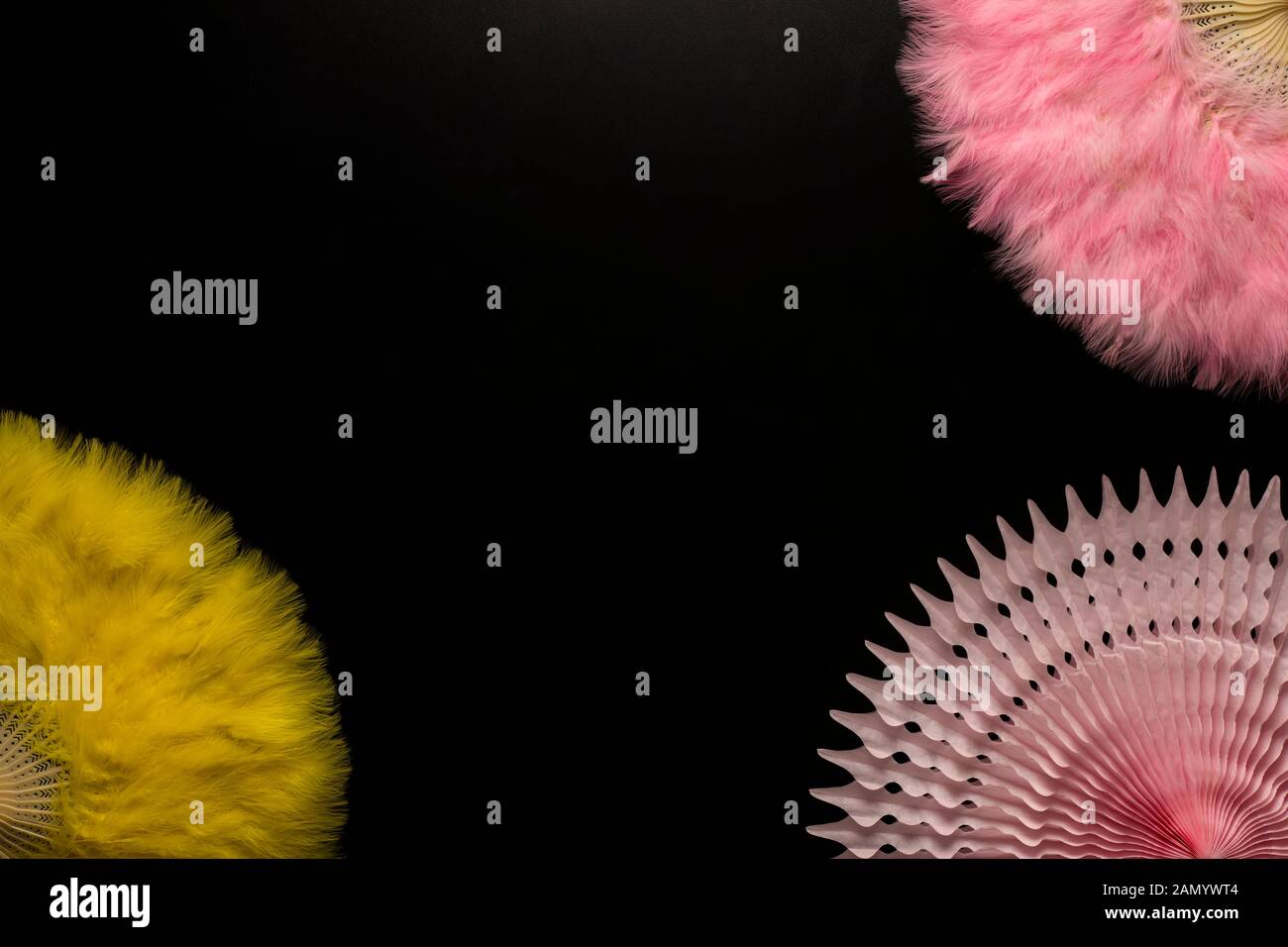 Carnival objects on a black background. Pink and yellow Chinese fans ...