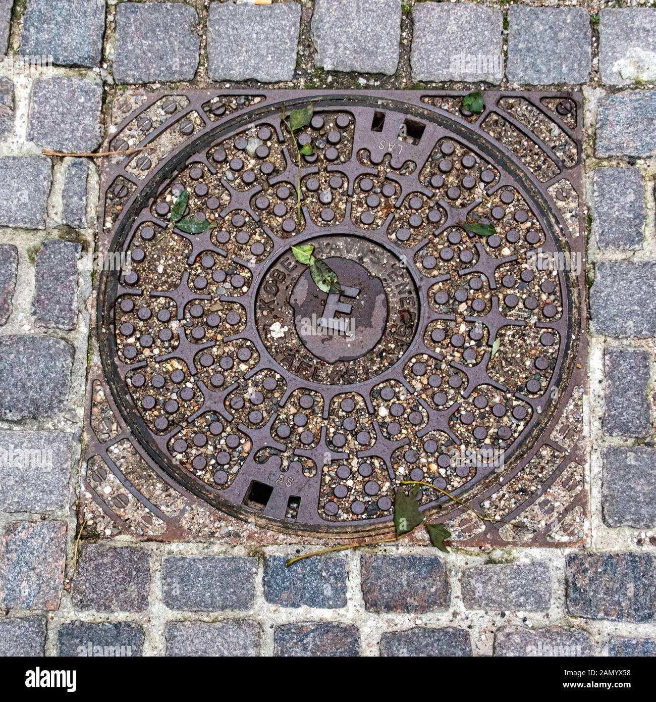 Manhole cover to access utility services in Copenhagen, Denmark Stock ...