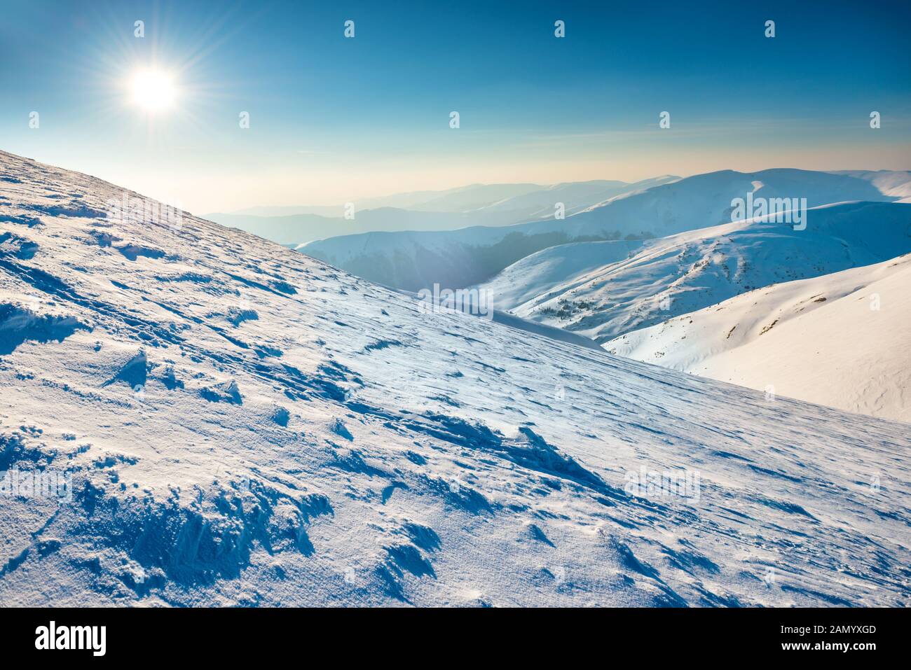 Bright sun in winter mountains covered with snow Stock Photo - Alamy