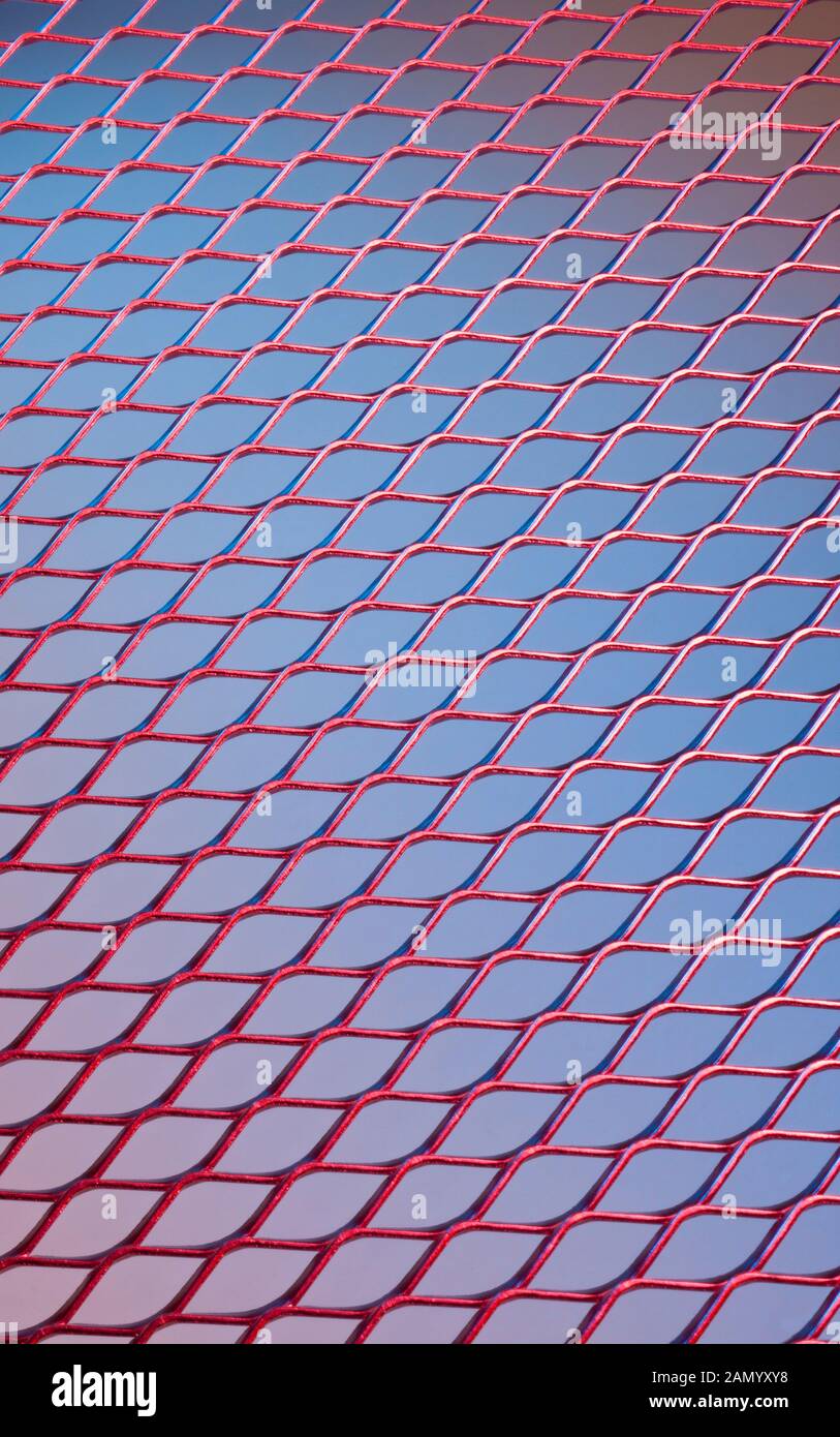 Red wire mesh on a blue background Stock Photo - Alamy