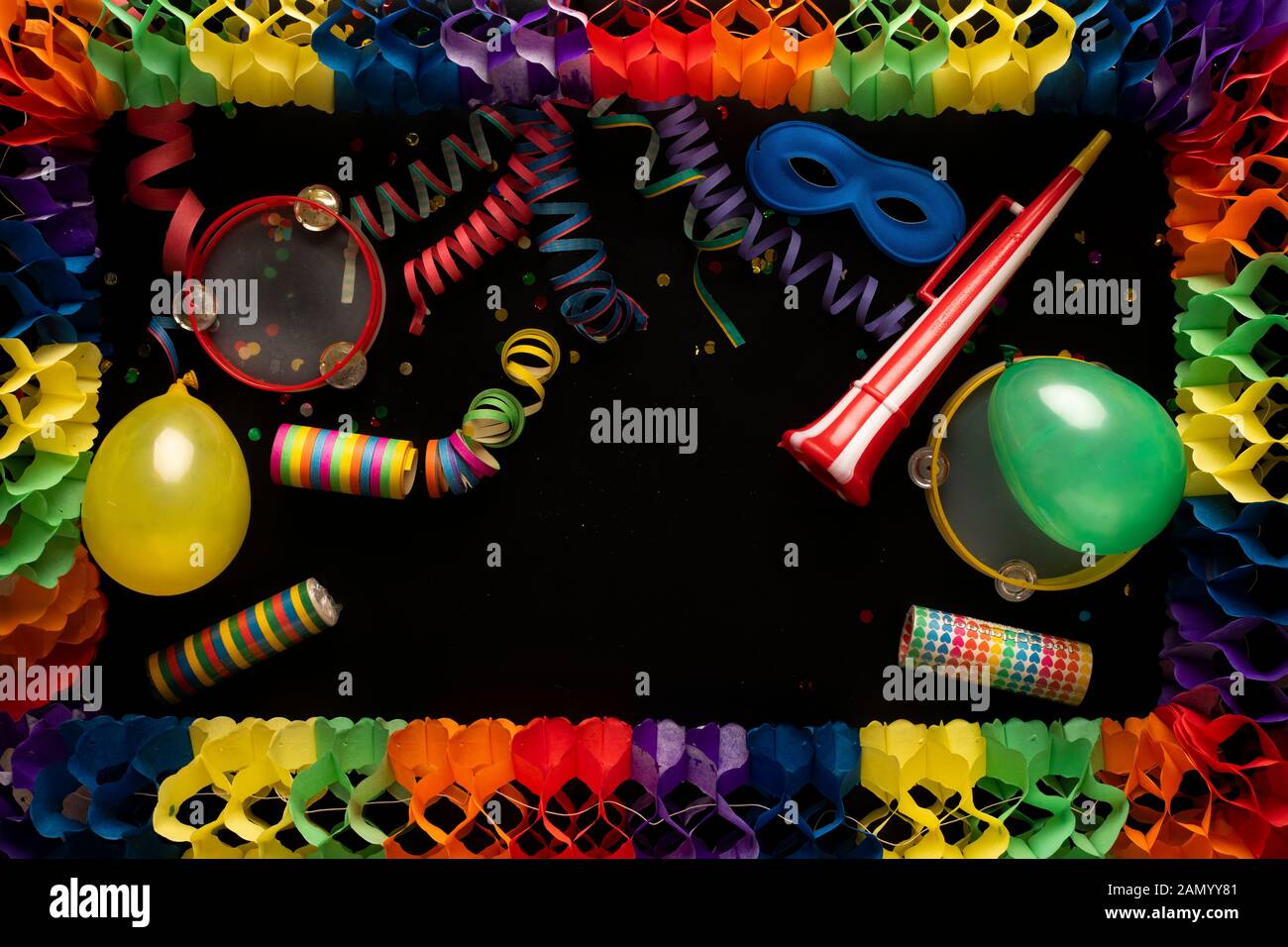 Carnival objects on a black background. Coiled streamers, confetti ...