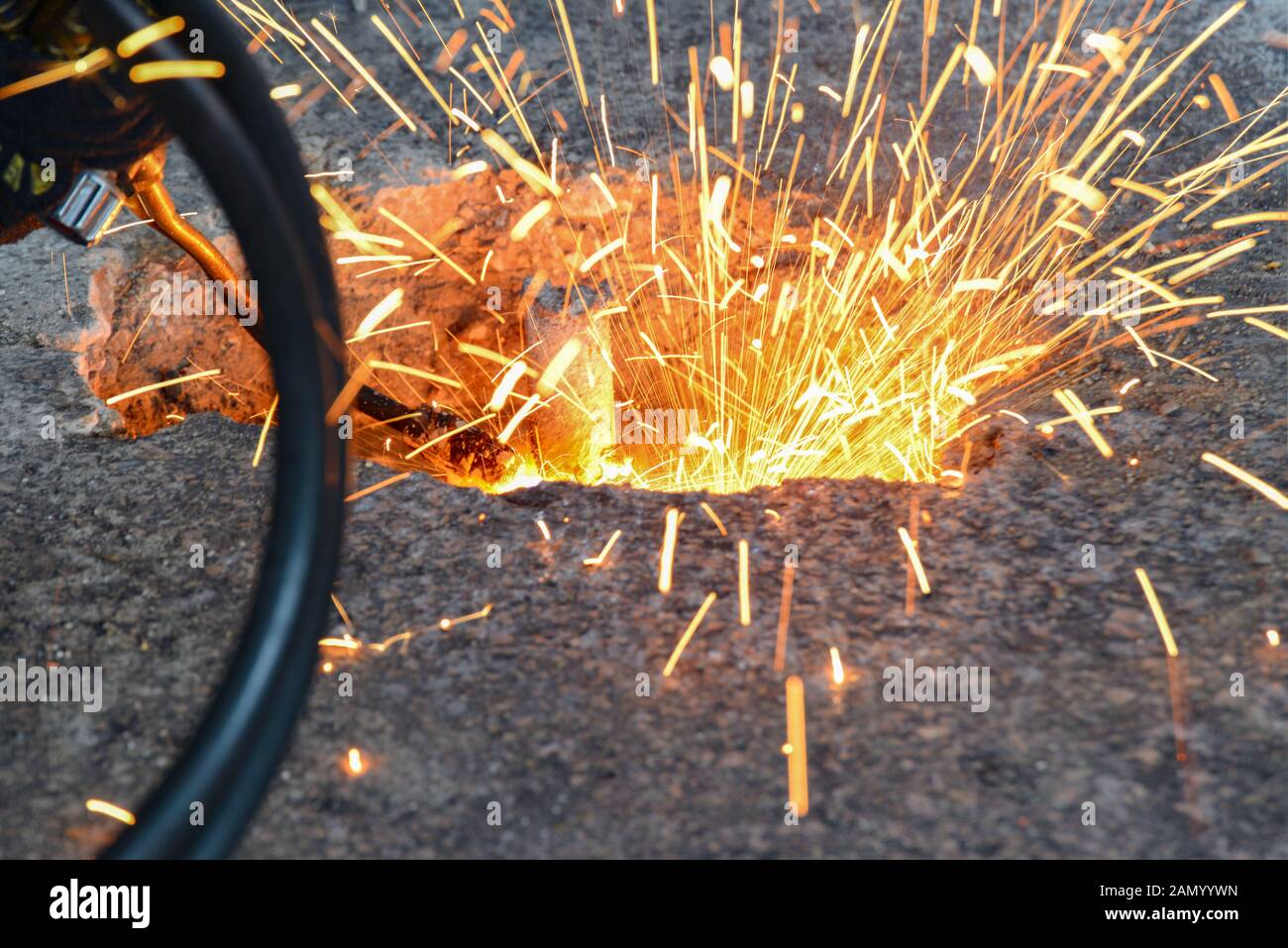 A gas cutter in production, a welder removes unnecessary metal residues ...