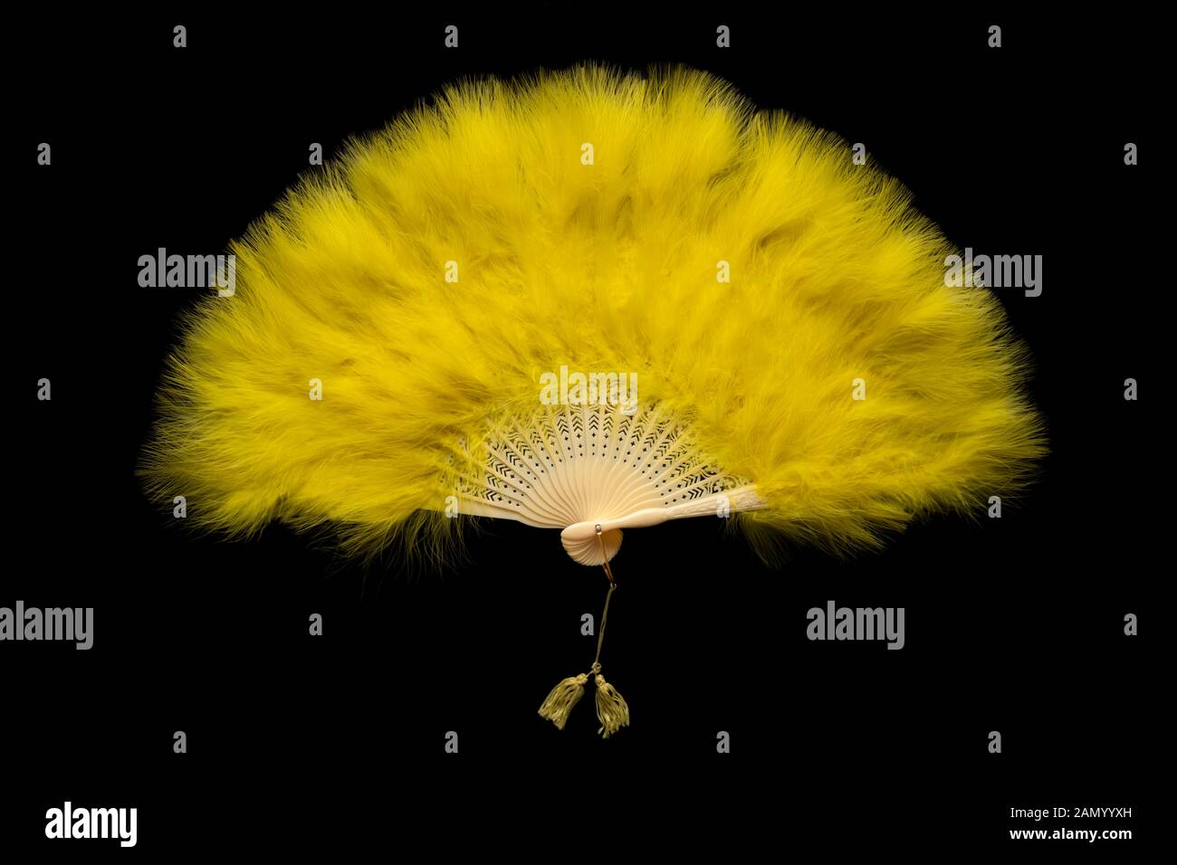 Yellow Chinese folding fan on a black background Stock Photo - Alamy