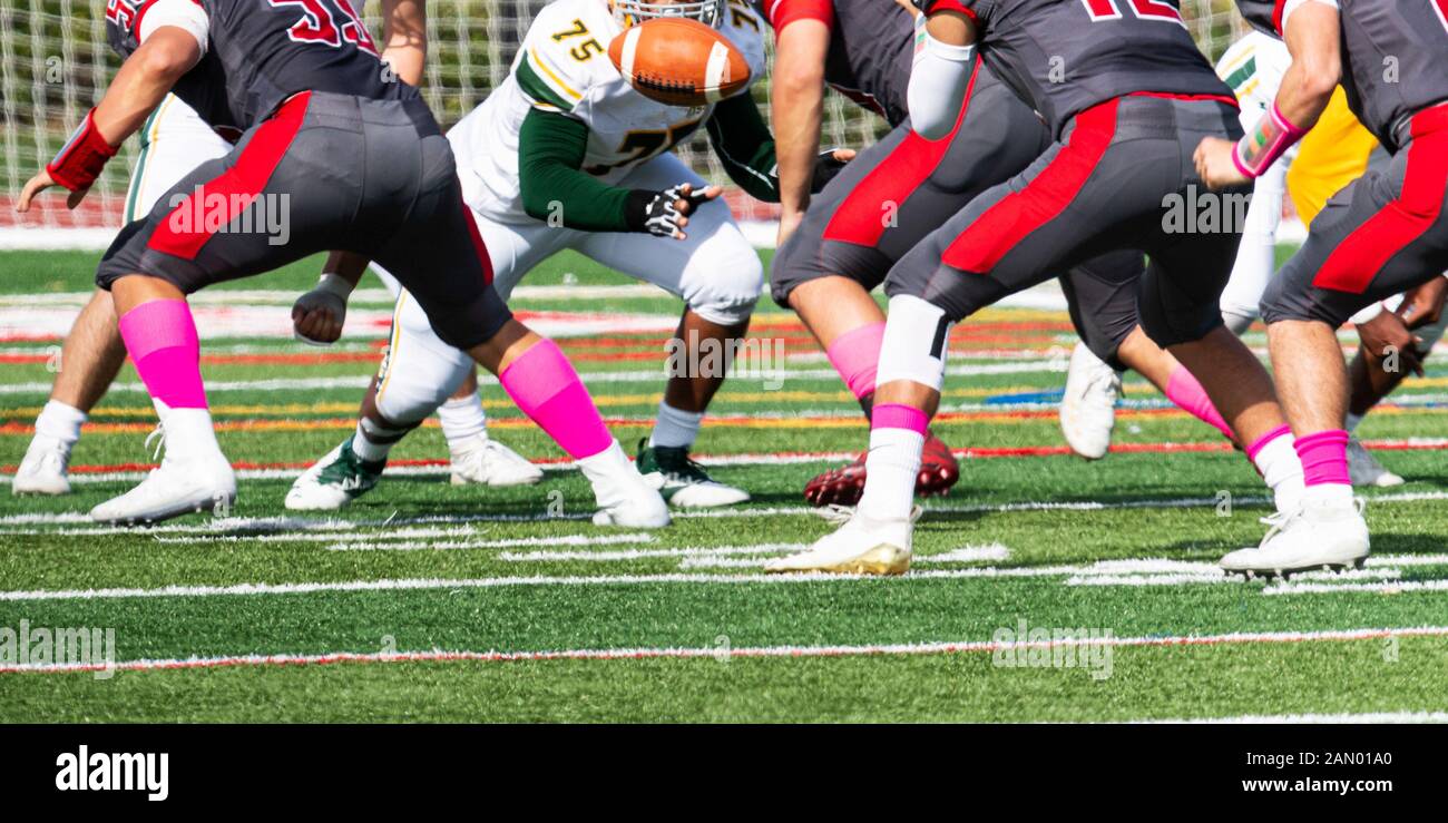 The football is in the air after the center snaps it to the quarterback ...