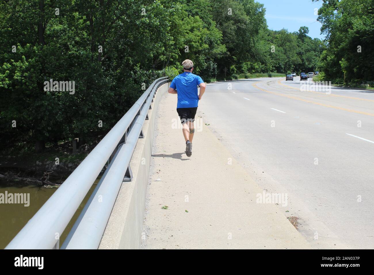 Man running over the Oakton Street Bridge pver tje Des Plaines River in ...