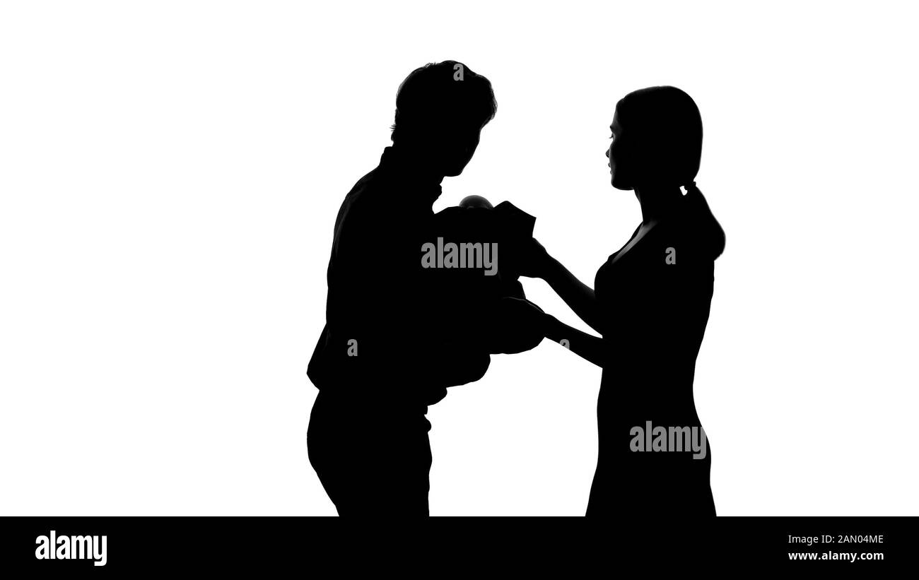 Mother giving newborn baby to happy father, planned child born in ...