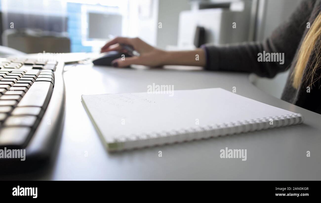 Female secretary clicking pc mouse, searching important data on ...