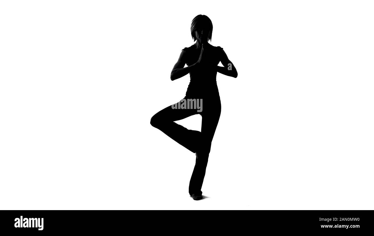 Young female shadow practicing yoga, tree pose exercise, soul and body ...