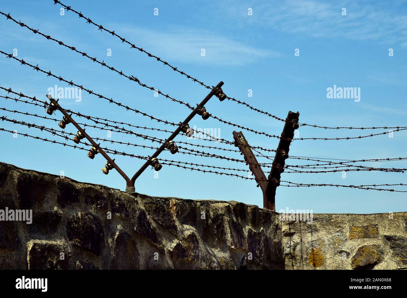 Austria, barbed wire fence on wall in NS concentration camp Mauthausen ...