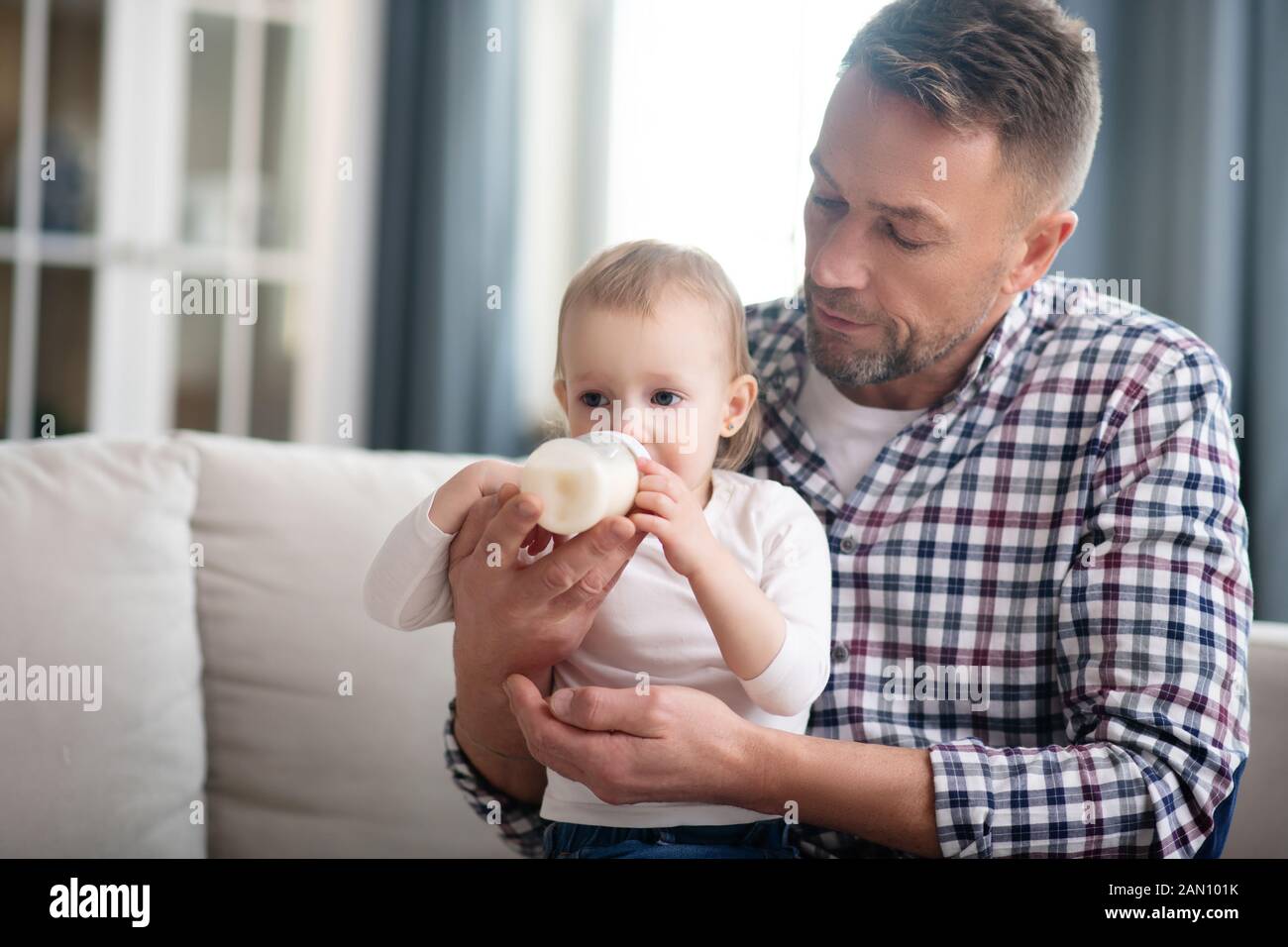 Father taking care of baby hi-res stock photography and images - Alamy