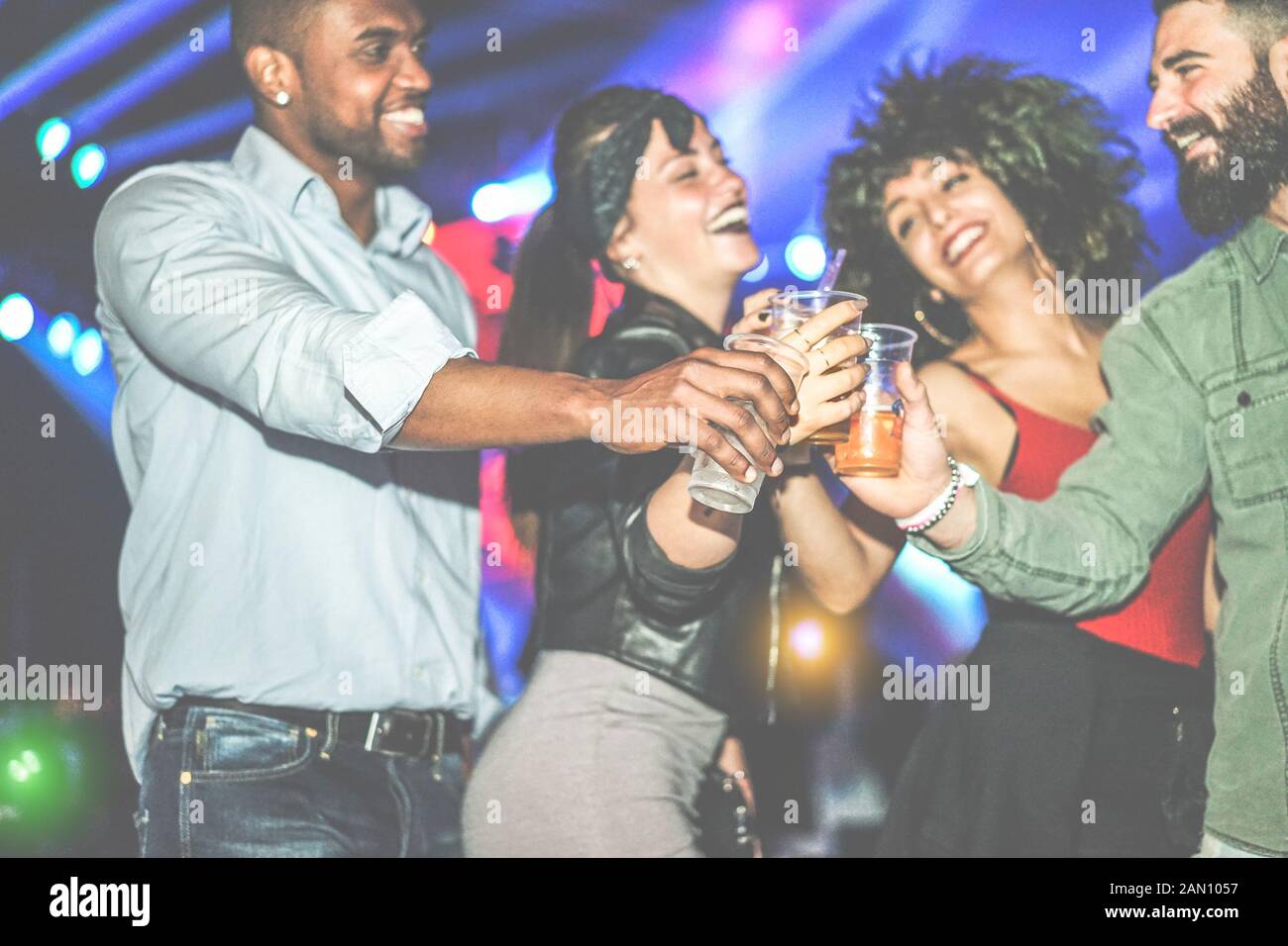 Happy diverse culture friends having party in club at night - Young ...