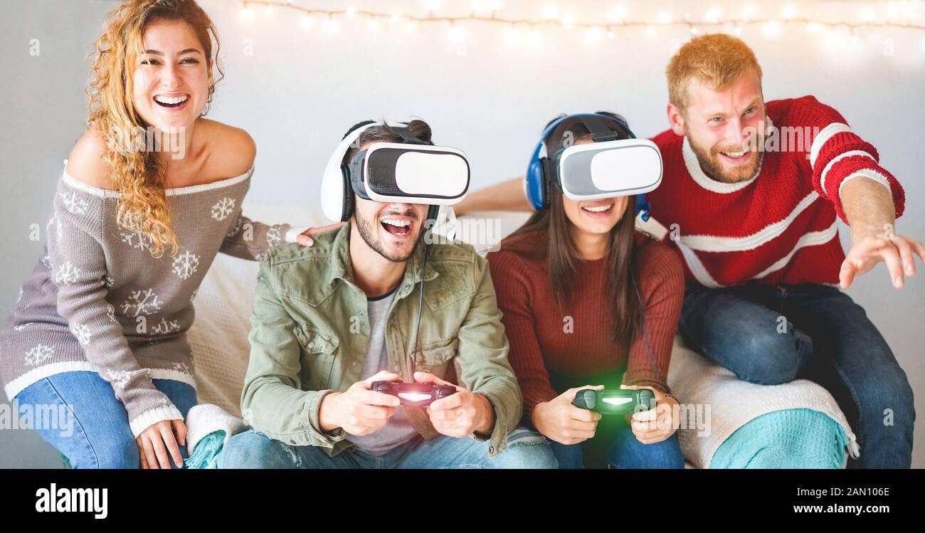 Group of millennials friends playing video games with virtual reality ...