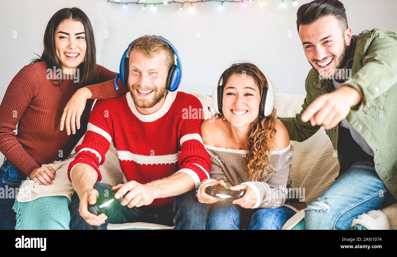 Group of millennials friends playing video games - Young people having ...