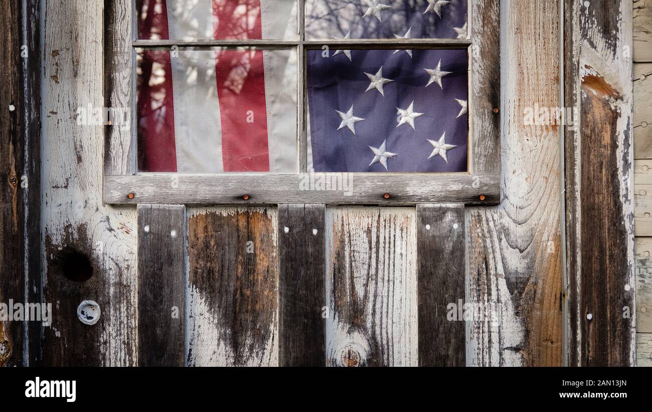 The American flag in a shed window, Maine Stock Photo - Alamy