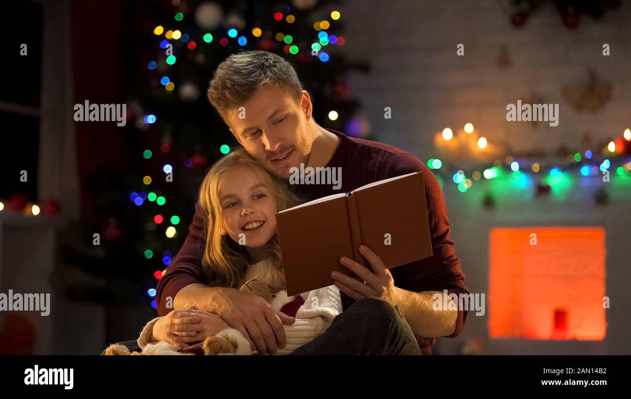 Reading near christmas tree hi-res stock photography and images - Alamy