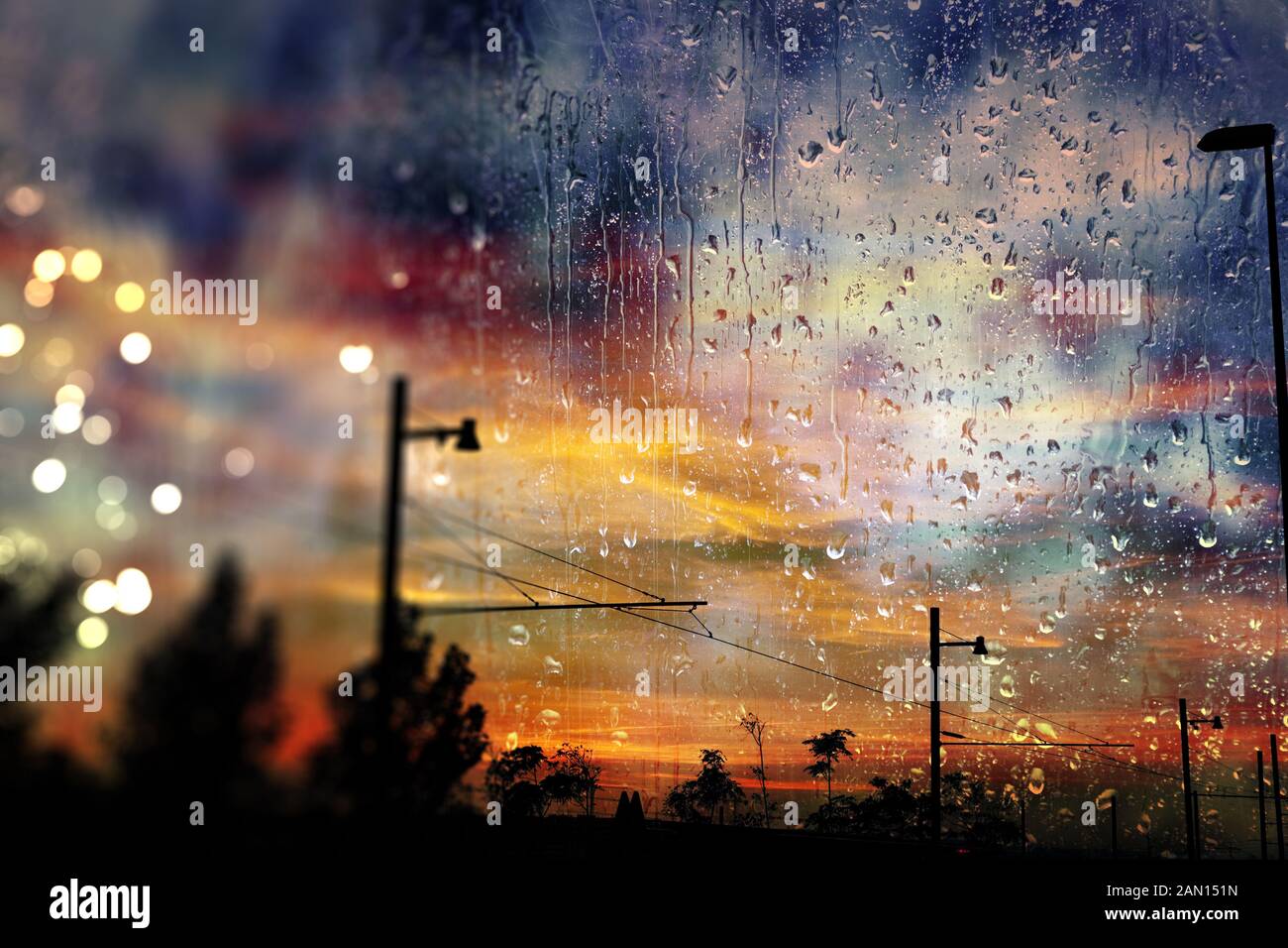 Rainy day through the window. Sunset and city street at night Stock ...