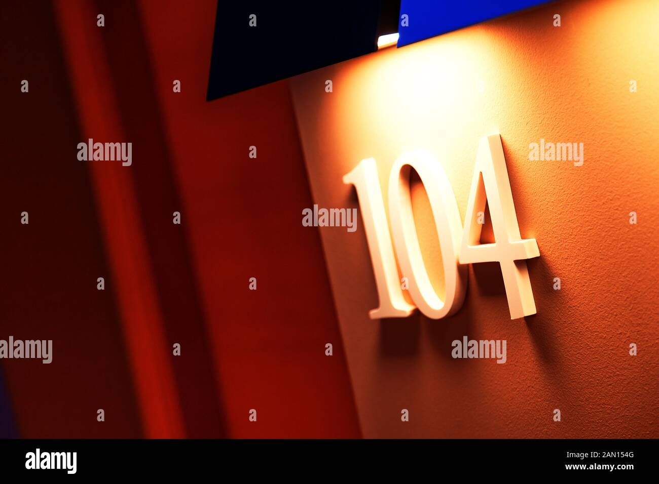 Room number on the wall and door detail with dim light.Hotel and ...