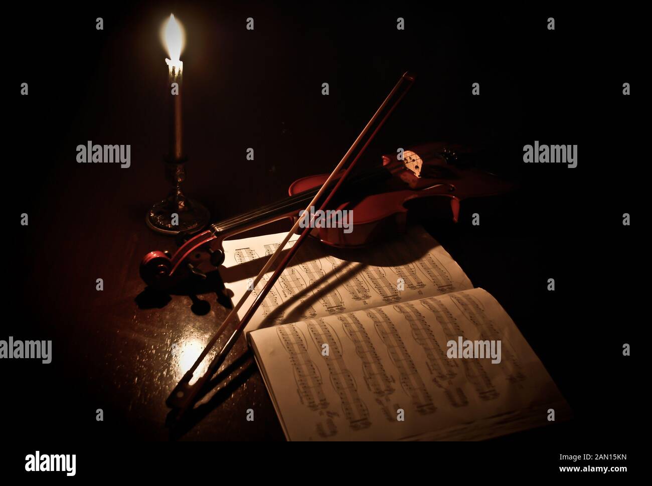 Violin and musical notes close-up. Brown vintage violin and bow on ...