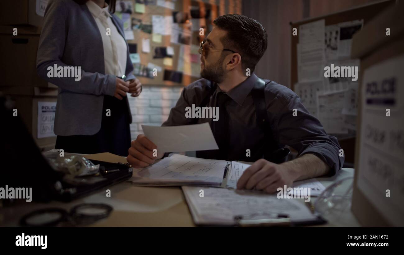 Policemen partners discussing criminal case, good teamwork ...