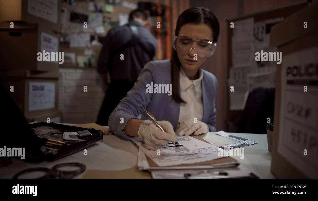 Lady detective checking criminal fingerprints database, examining ...