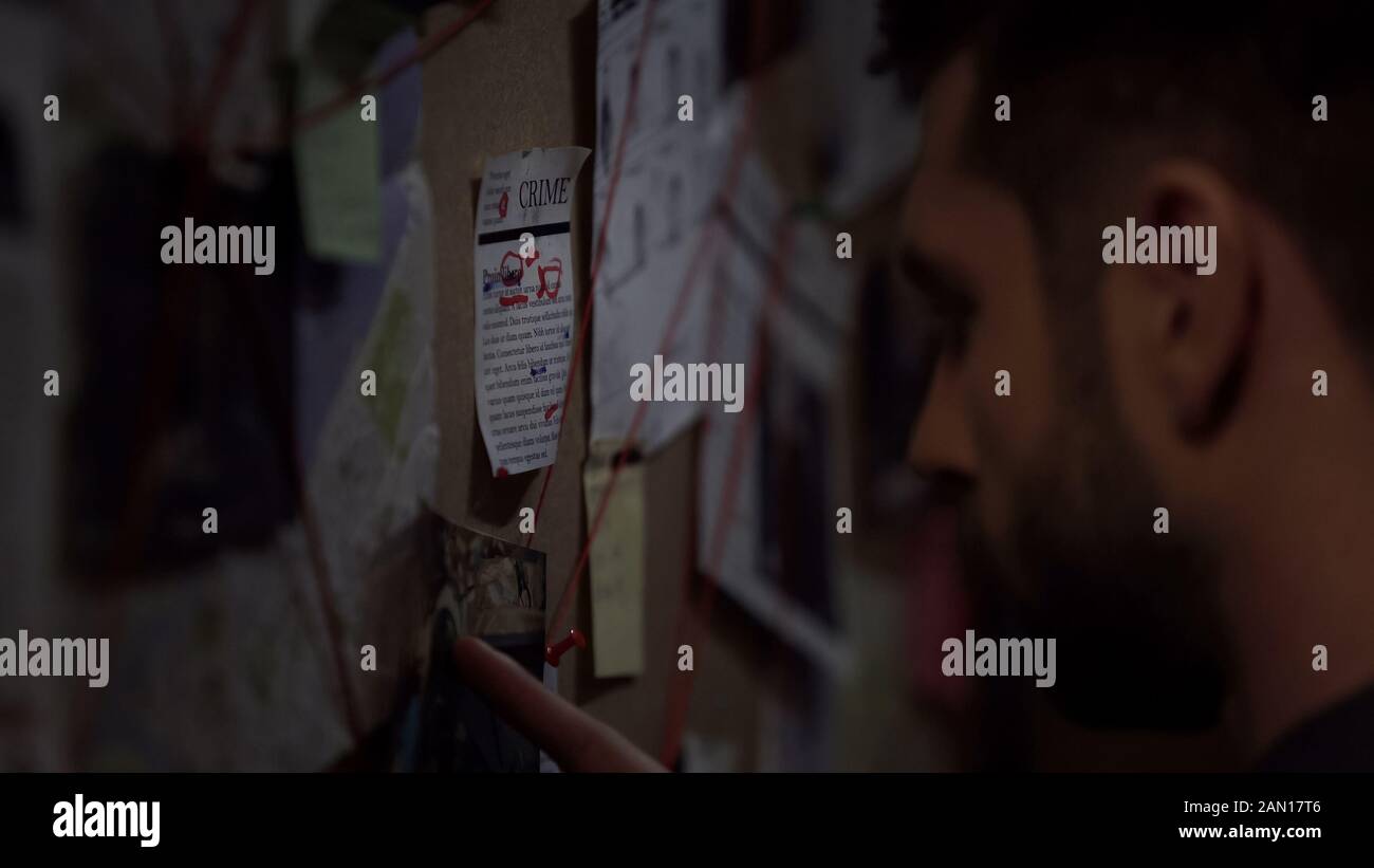 Confident secret agent searching for the criminal on the map, finding ...