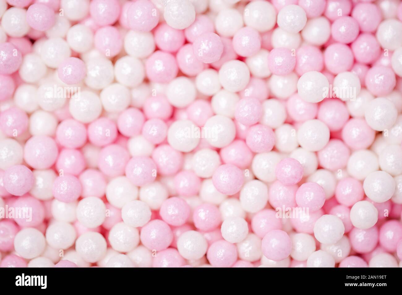 Pastel pink and white background. Sweet sugar balls. Sprinkles sugar ...