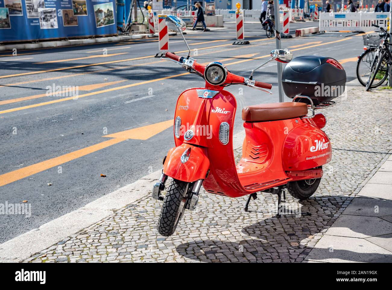 Red scooter on a city street Stock Photo - Alamy