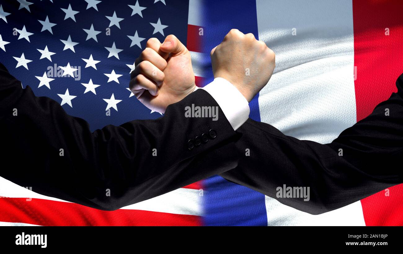 US vs France confrontation, countries disagreement, fists on flag ...