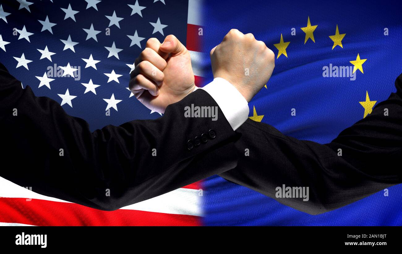 US vs EU confrontation, countries disagreement, fists on flag ...
