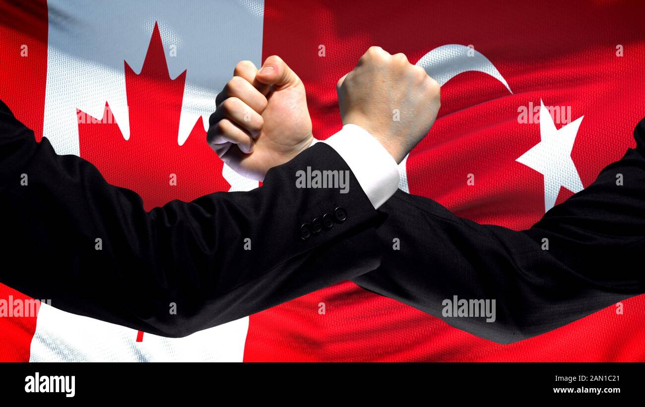 Canada vs Turkey confrontation, countries disagreement, fists on flag ...