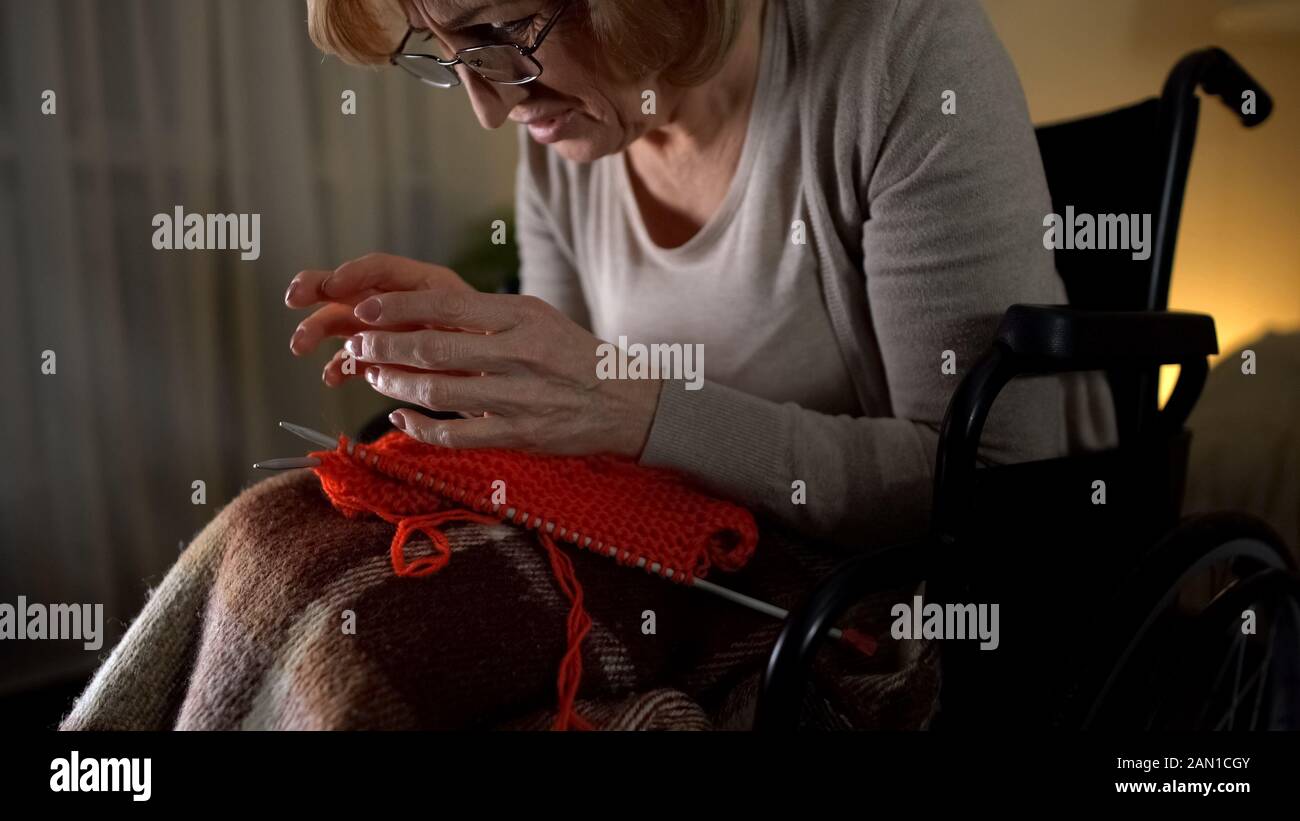 Retire lady in despair looking at shaking hands, crying helplessly in ...