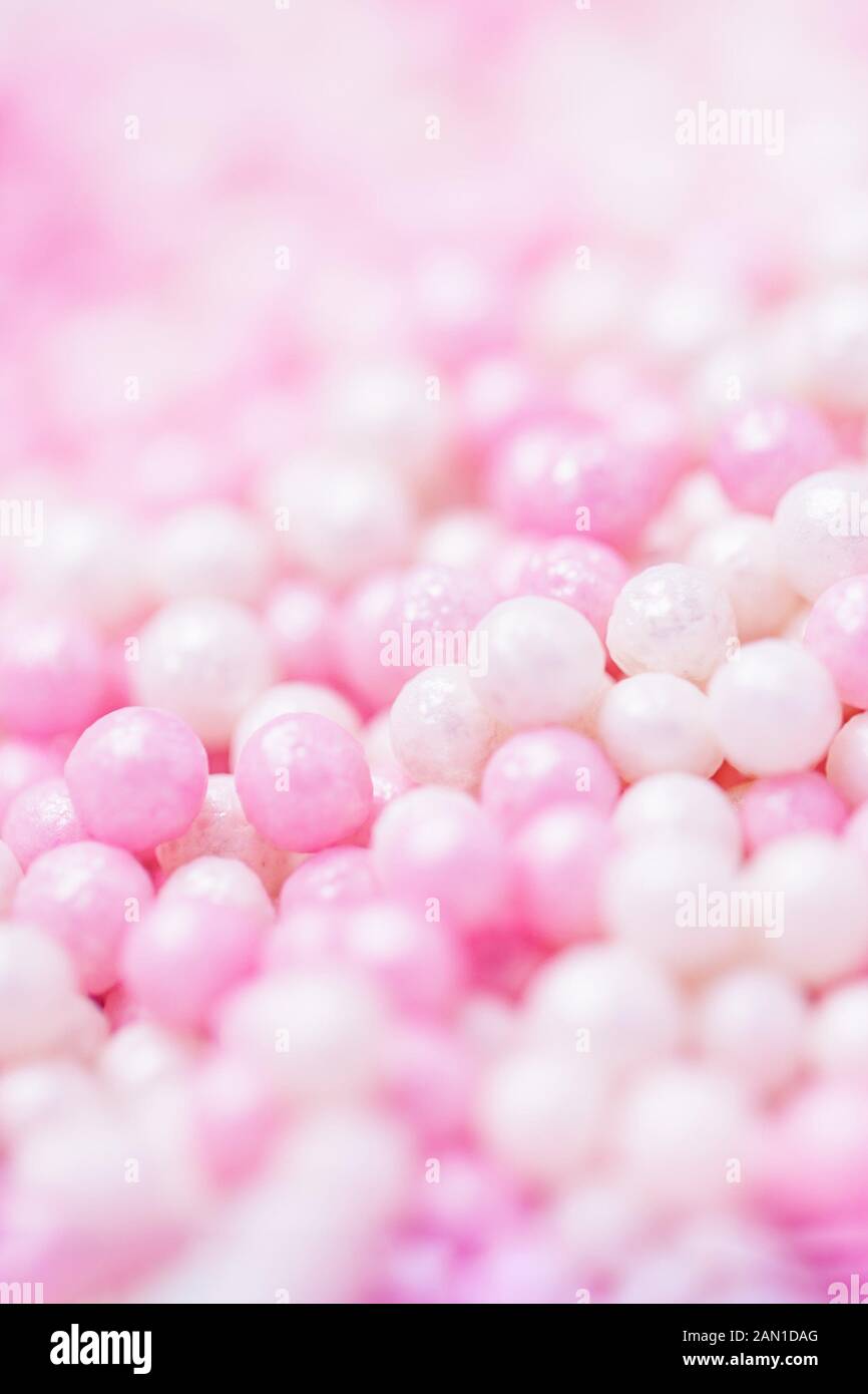Pastel pink and white background. Sweet sugar balls. Sprinkles sugar ...