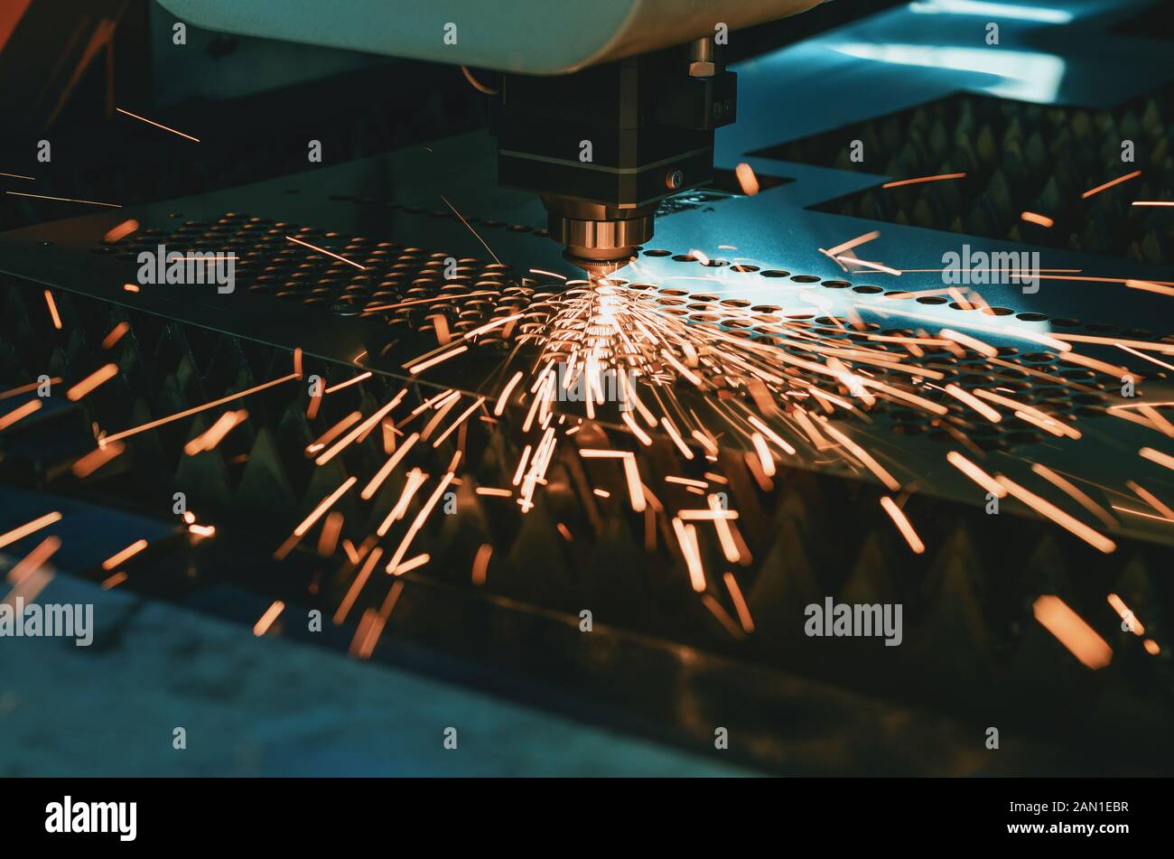 Machine for laser cutting of metal. Laser head cuts the sheet with a ...