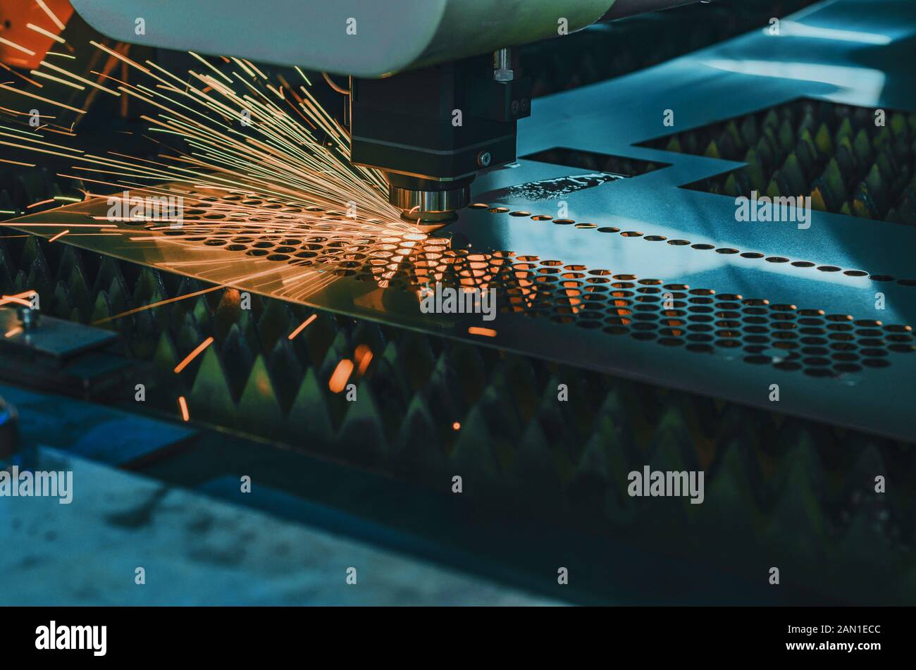 Machine for laser cutting of metal. Laser head cuts the sheet with a ...
