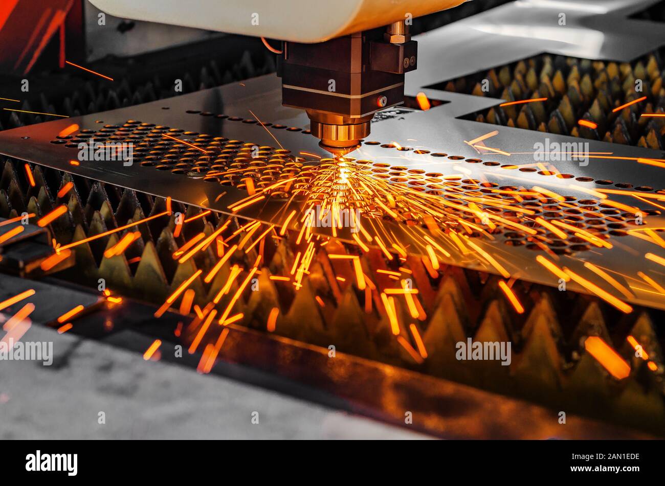 Machine for laser cutting of metal. Laser head cuts the sheet with a ...